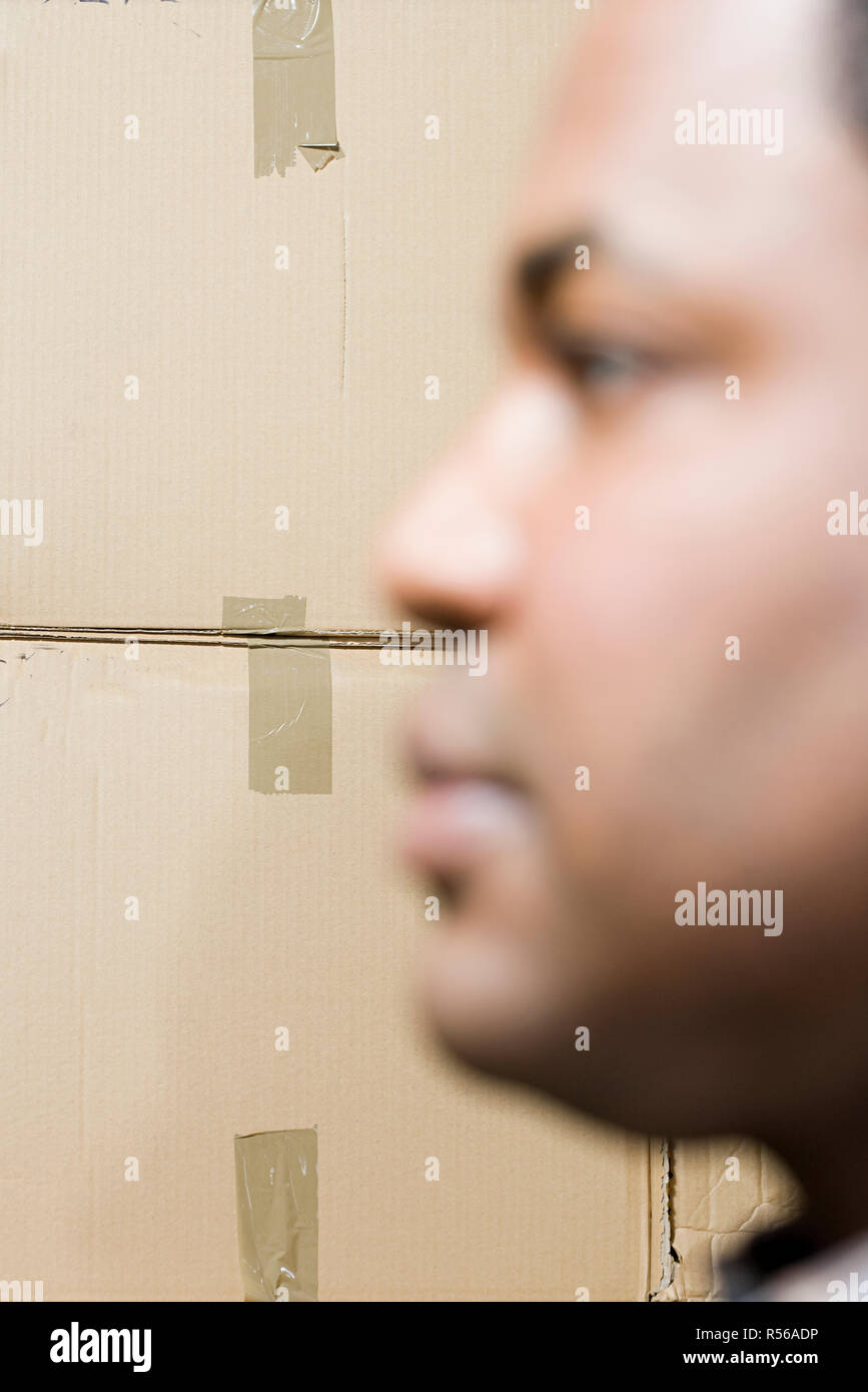 Boxes and face of a man Stock Photo - Alamy