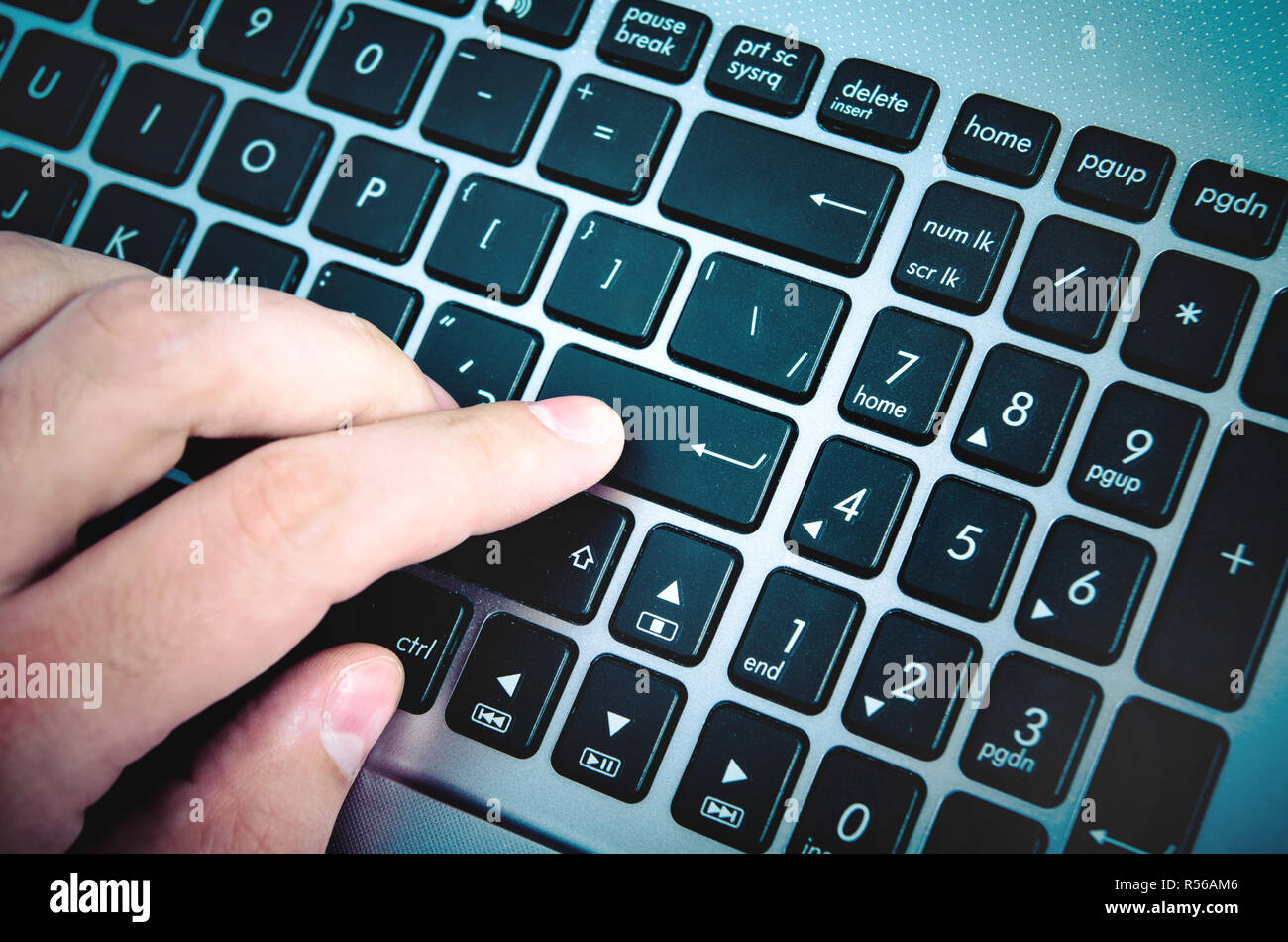 closeup of a finger pressing laptop keyboard Stock Photo - Alamy