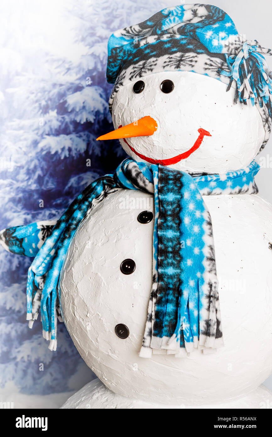 Smiling, happy snowman surrounded by winter landscape with falling snow ...
