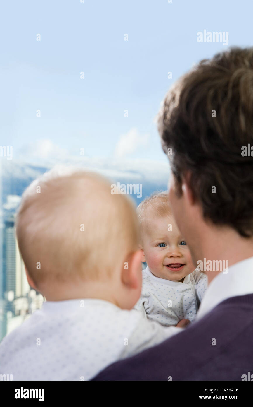 father and son looking at their reflection in a window Stock Photo - Alamy