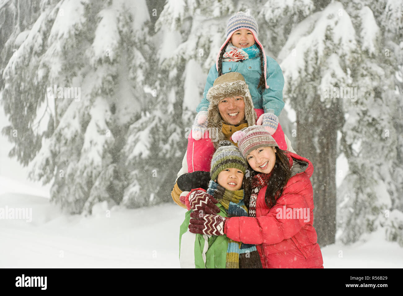 Family in the snow Stock Photo - Alamy