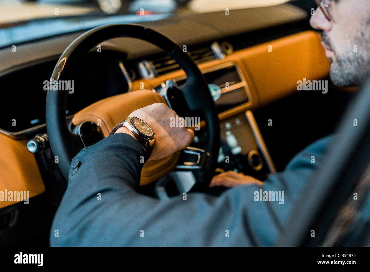 partial view of businessman checking watch in luxury car Stock Photo ...