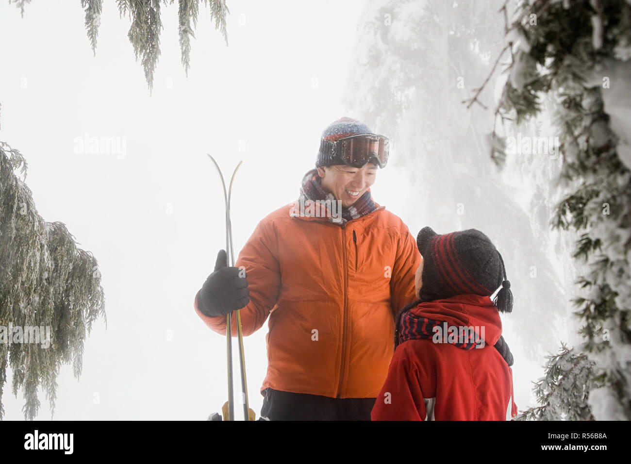 Father and son preparing to ski Stock Photo - Alamy