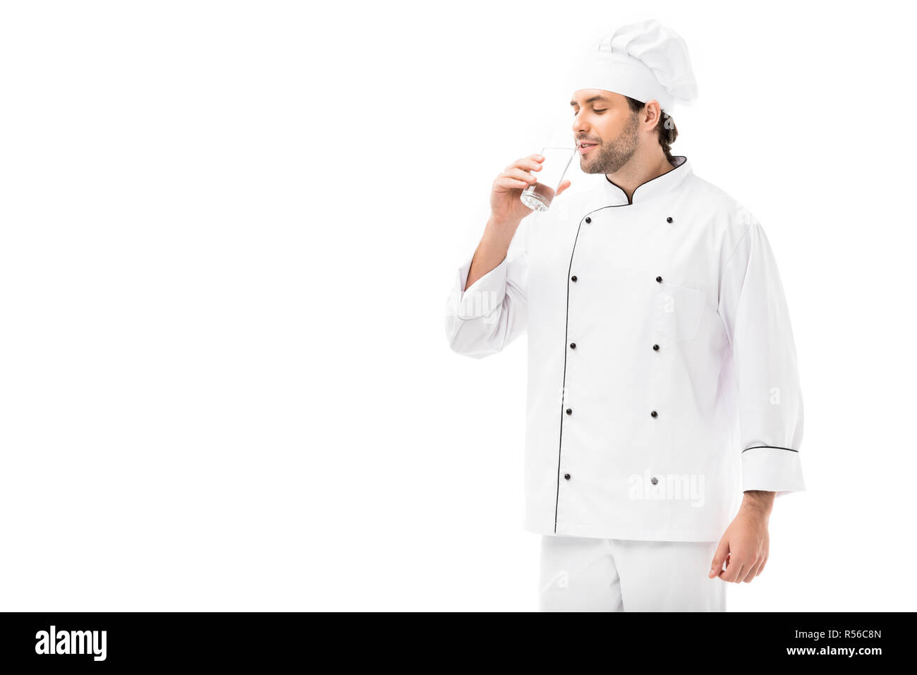 handsome young chef drinking water isolated on white Stock Photo - Alamy