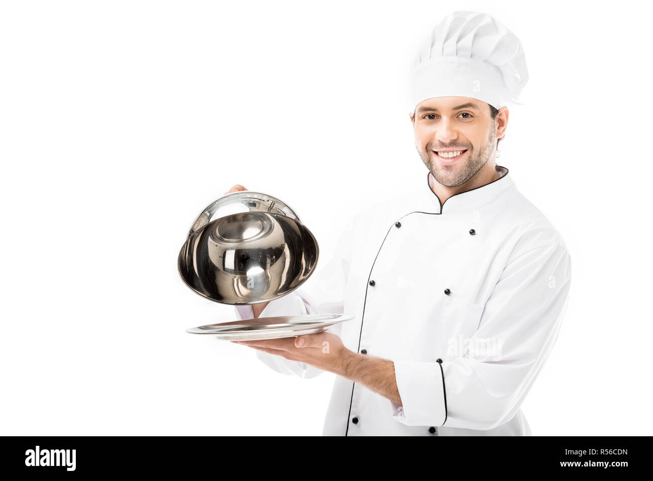smiling chef taking of serving dome from plate isolated on white Stock ...