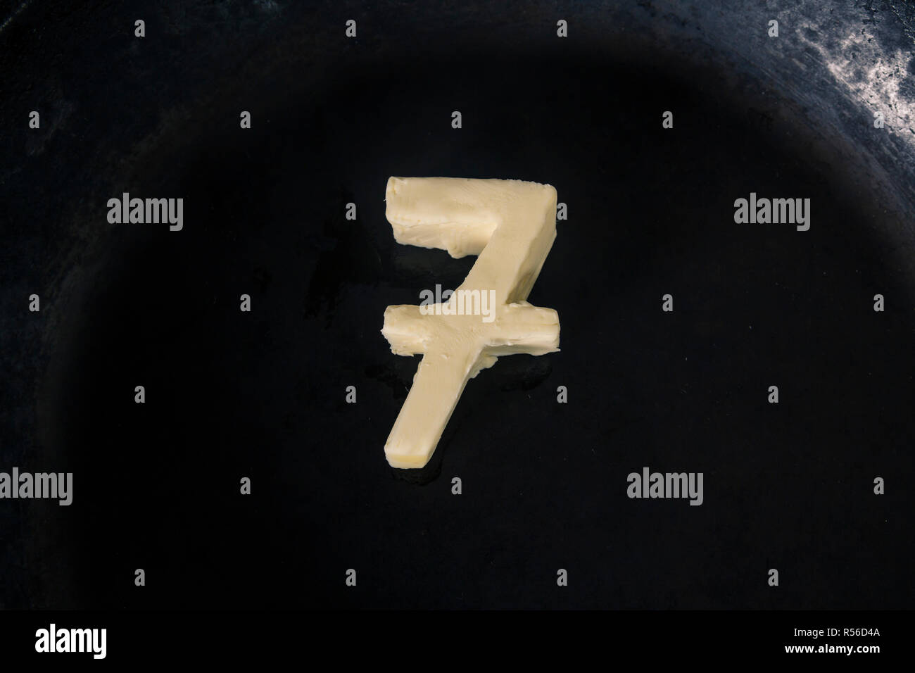 Butter in shape of number 7 on hot pan - Close up top view Stock Photo ...