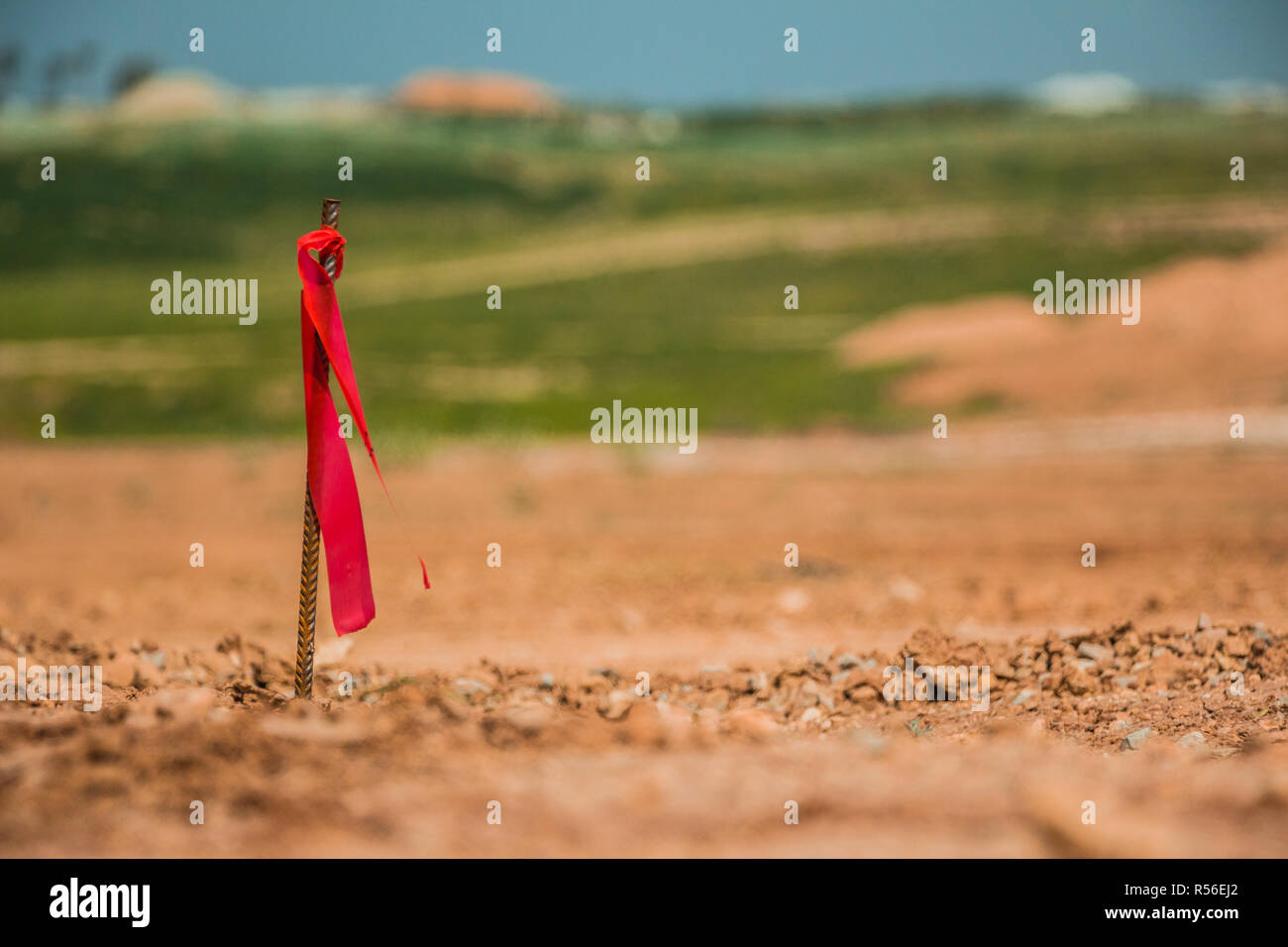 Metal survey peg with red flag on construction site Stock Photo - Alamy