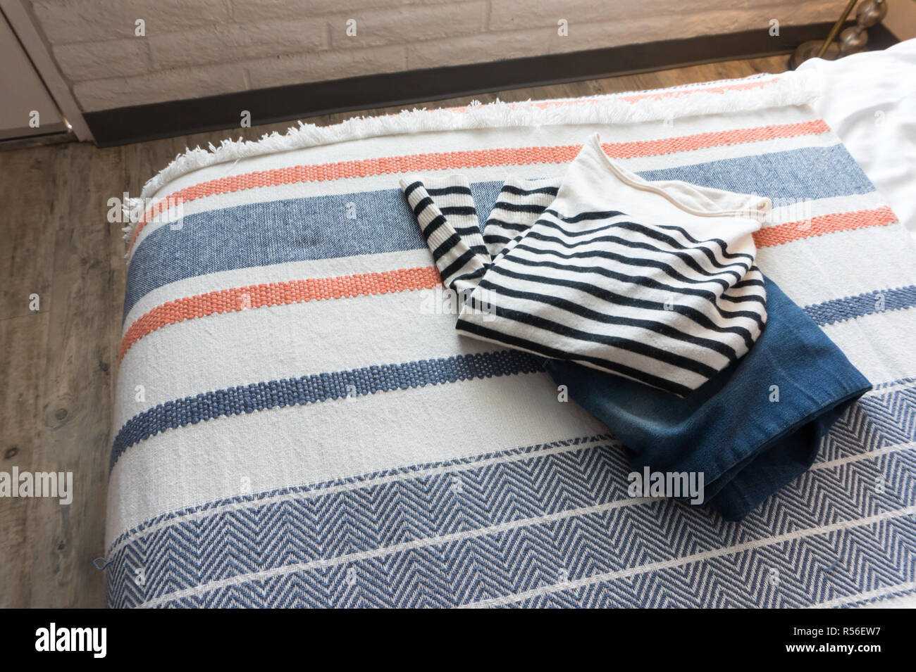 A woman's clothing laid out on a beautiful bed to get ready for the day ...