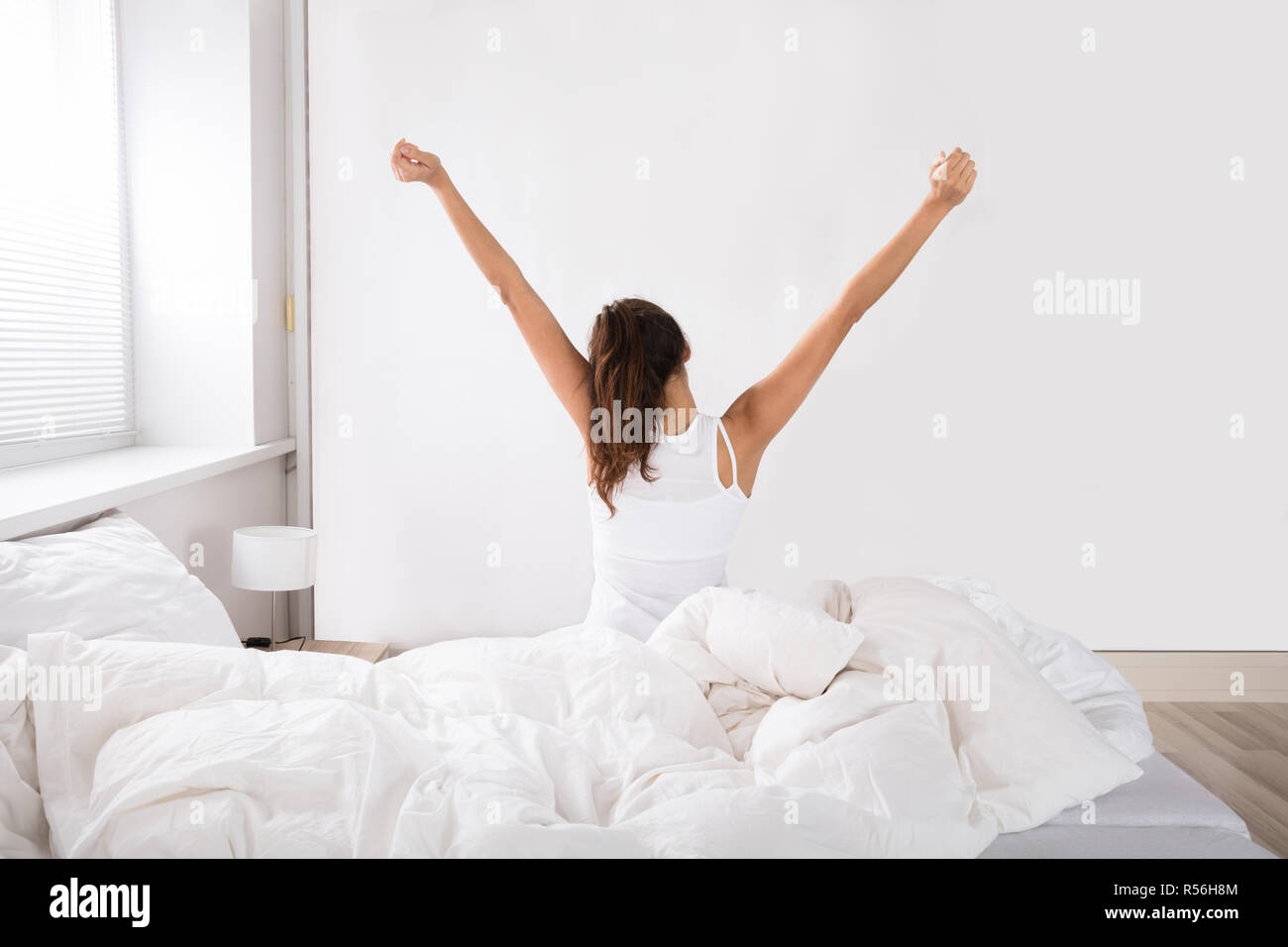 One woman wake up bed arms up happy hi-res stock photography and images ...