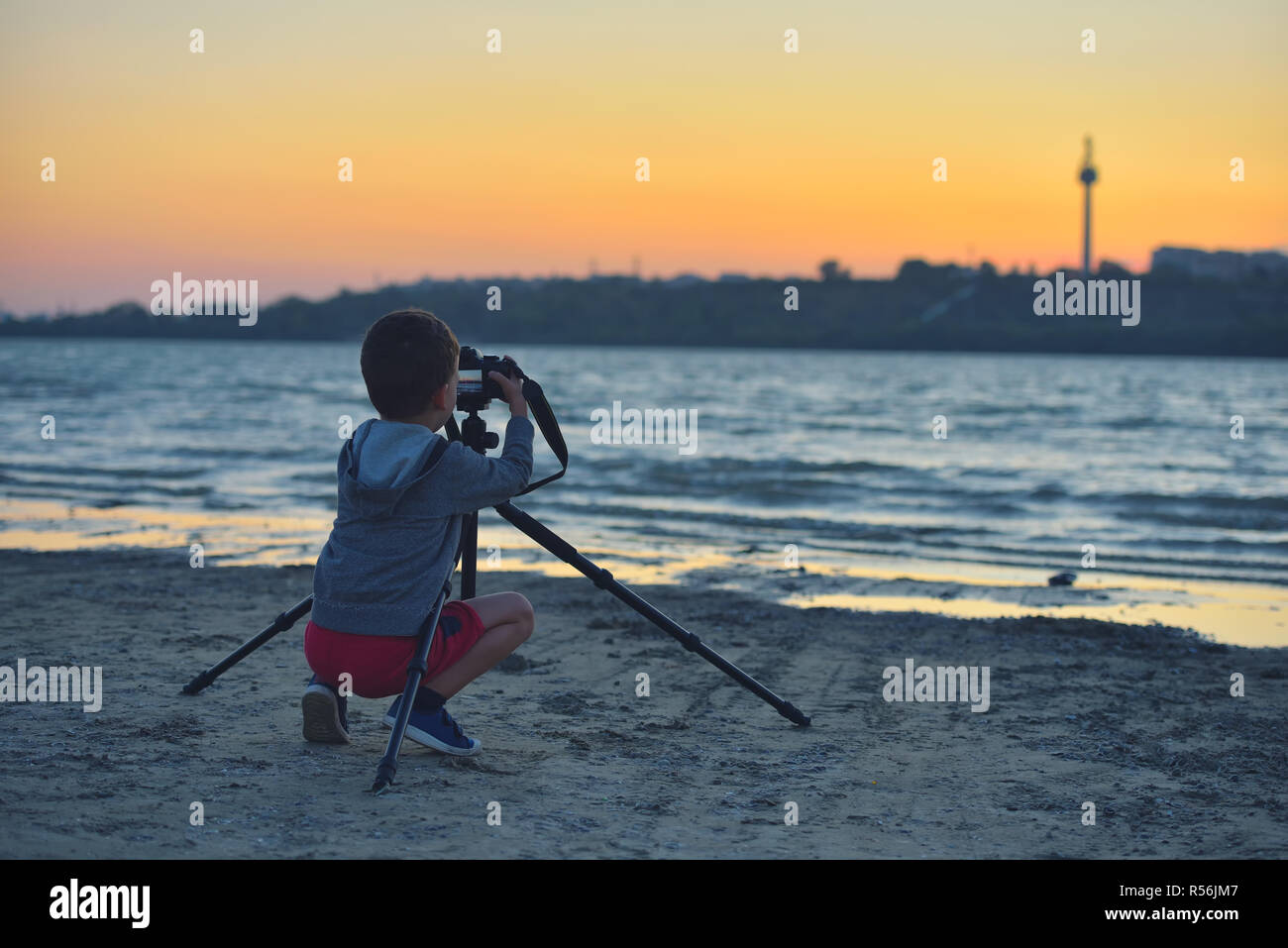 Creative child, kid photographer (a little boy) with a camera taking ...