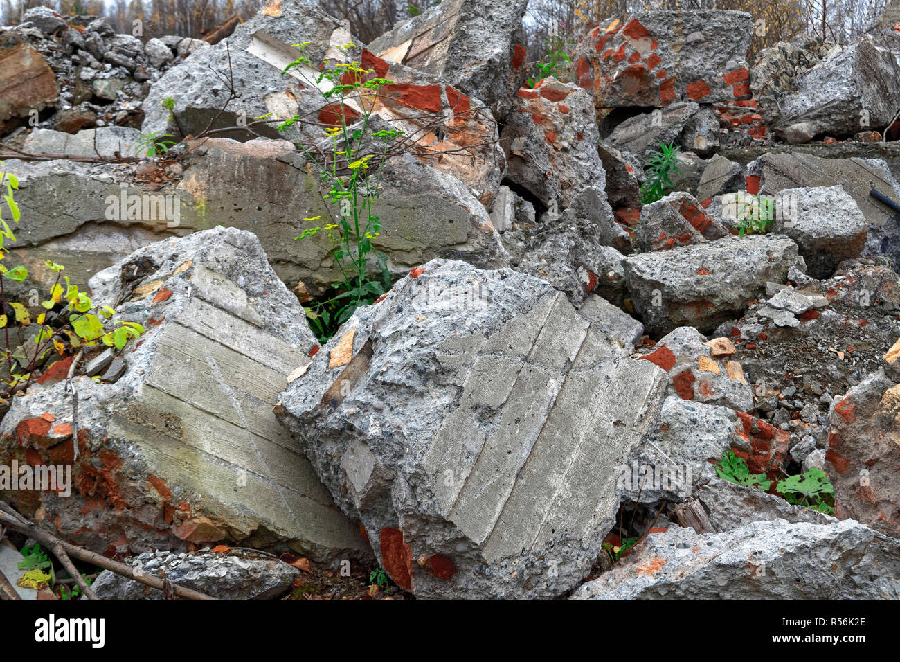 A pile of gray concrete debris from the pile and stones of the ...