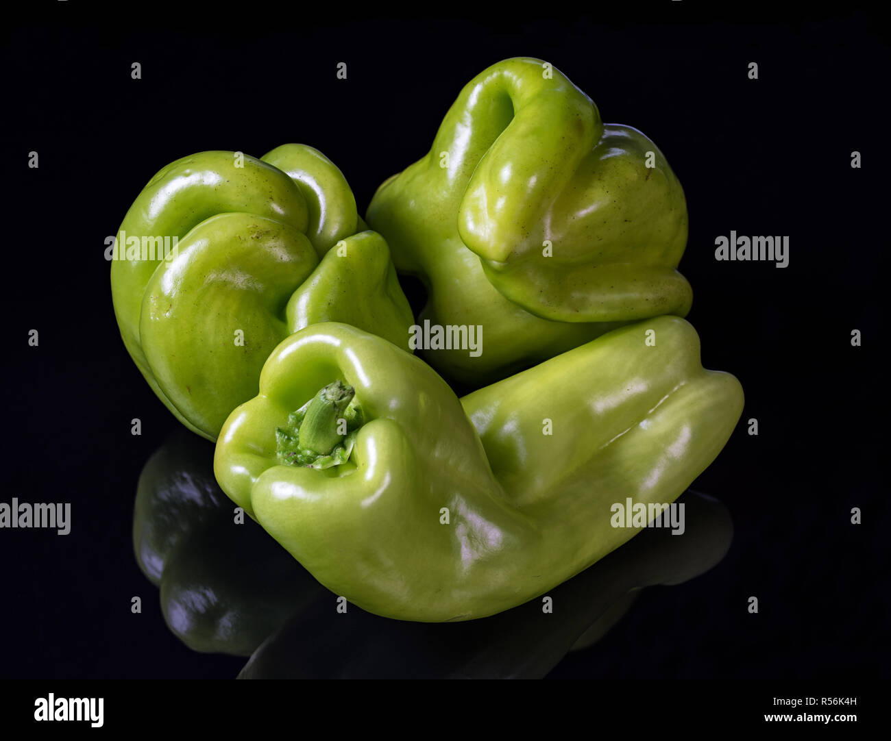 Still life of three elongated and convoluted bell peppers Stock Photo ...