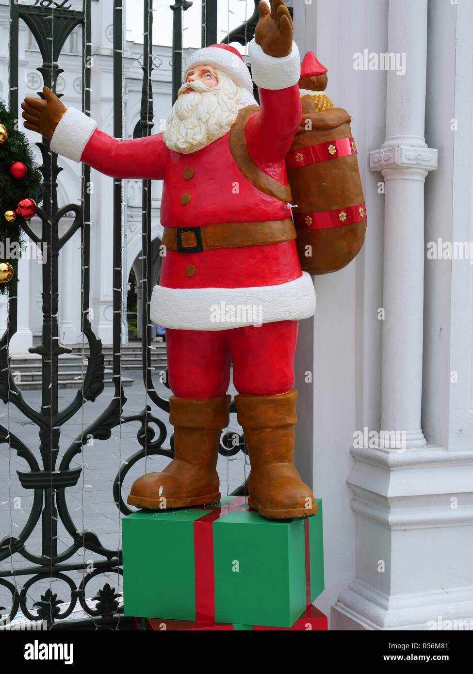 The life like figure of father Christmas in front of a gate with large ...