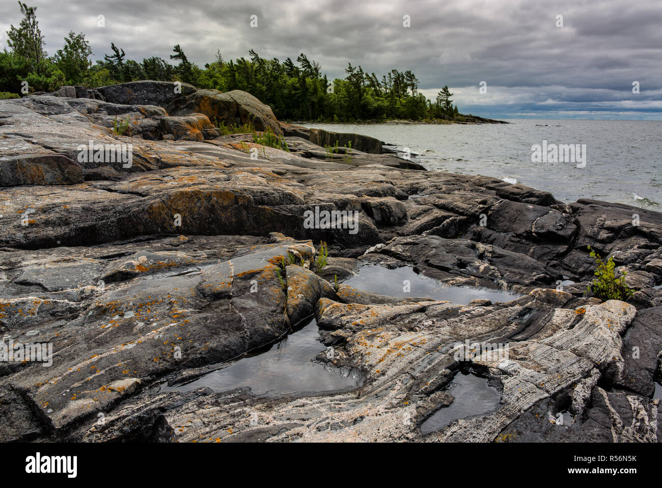 Multibanded gneiss rocks on the shoreline of an island among the 30,000 ...