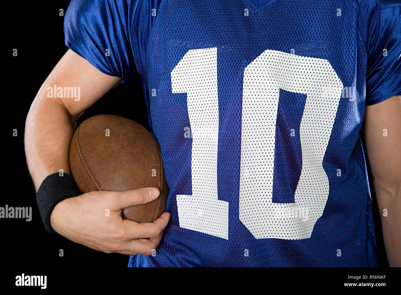 Man holding American football Stock Photo - Alamy