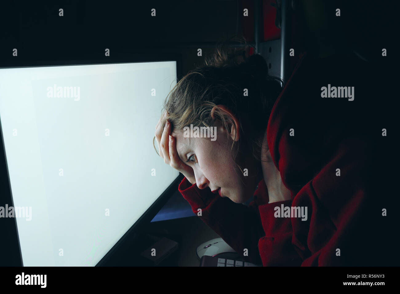 Young hacker woman in front of a white pc screen Stock Photo - Alamy
