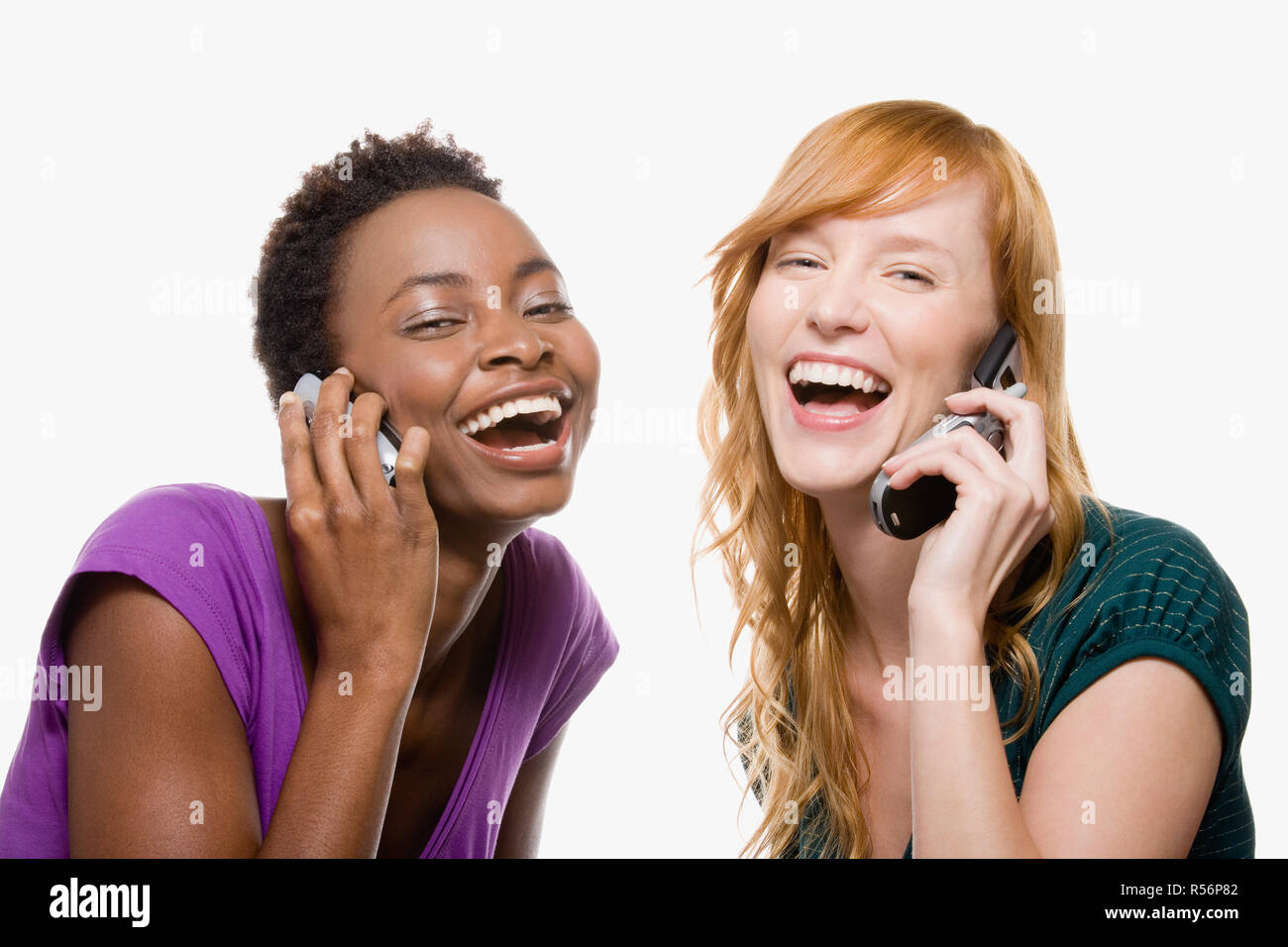 Friends using cell phone Stock Photo - Alamy