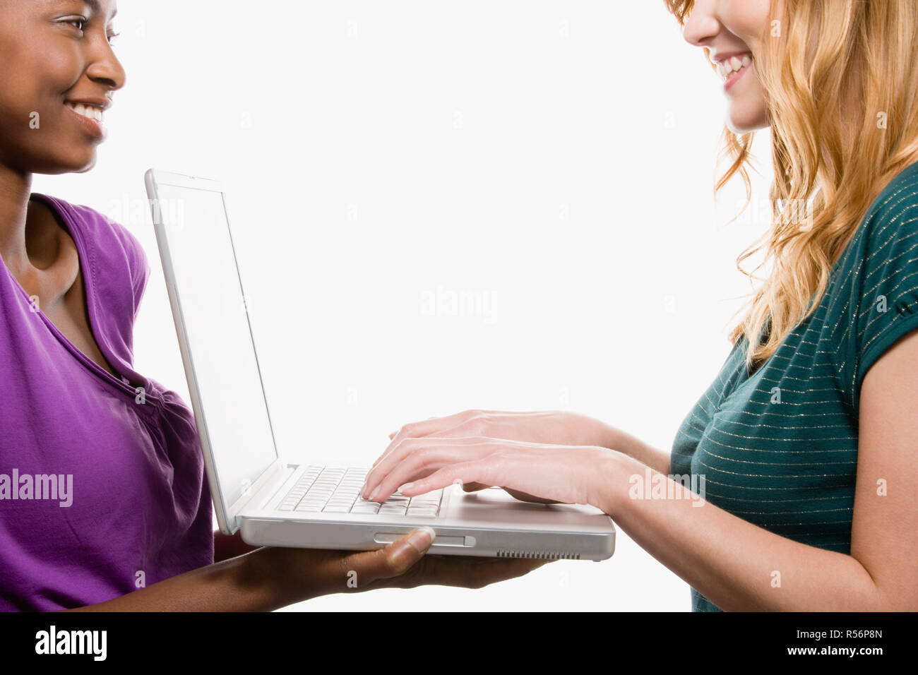 Friends using laptop Stock Photo - Alamy