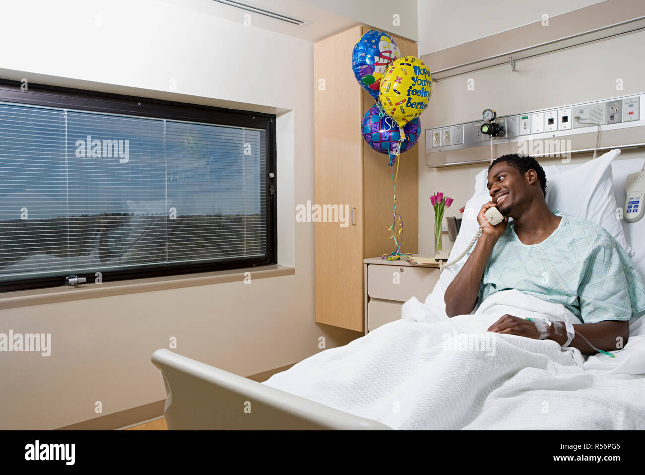 Patient on telephone in hospital bed Stock Photo - Alamy