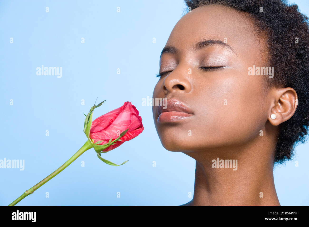 Woman smelling rose Stock Photo - Alamy