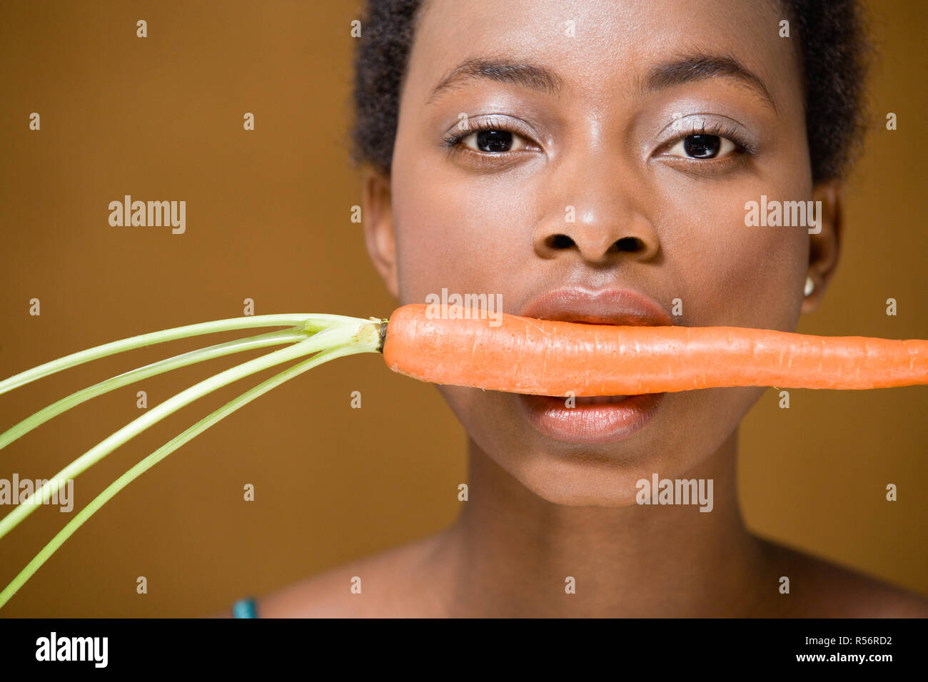 Young woman biting carrot hi-res stock photography and images - Alamy