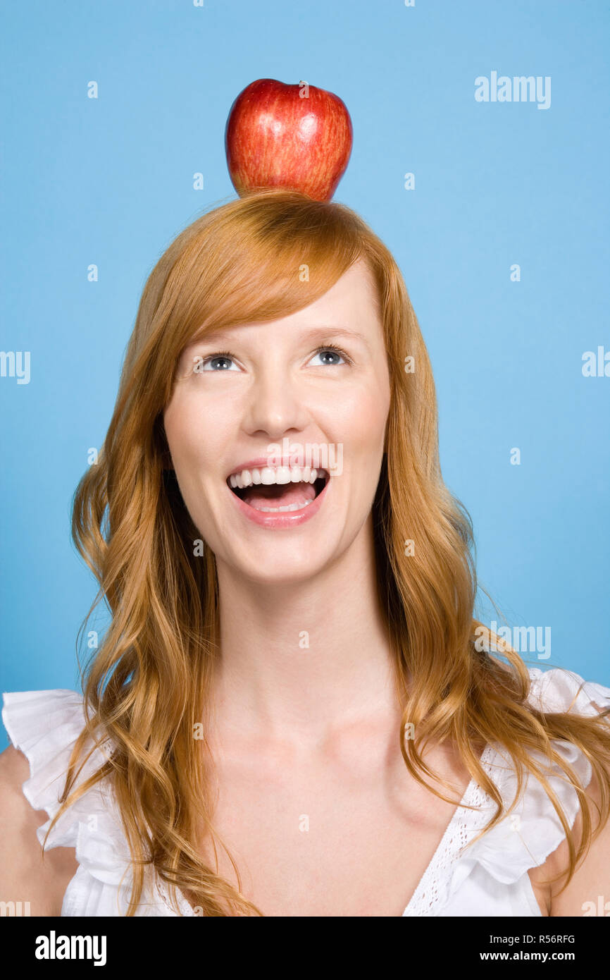 Woman with an apple on her head Stock Photo - Alamy