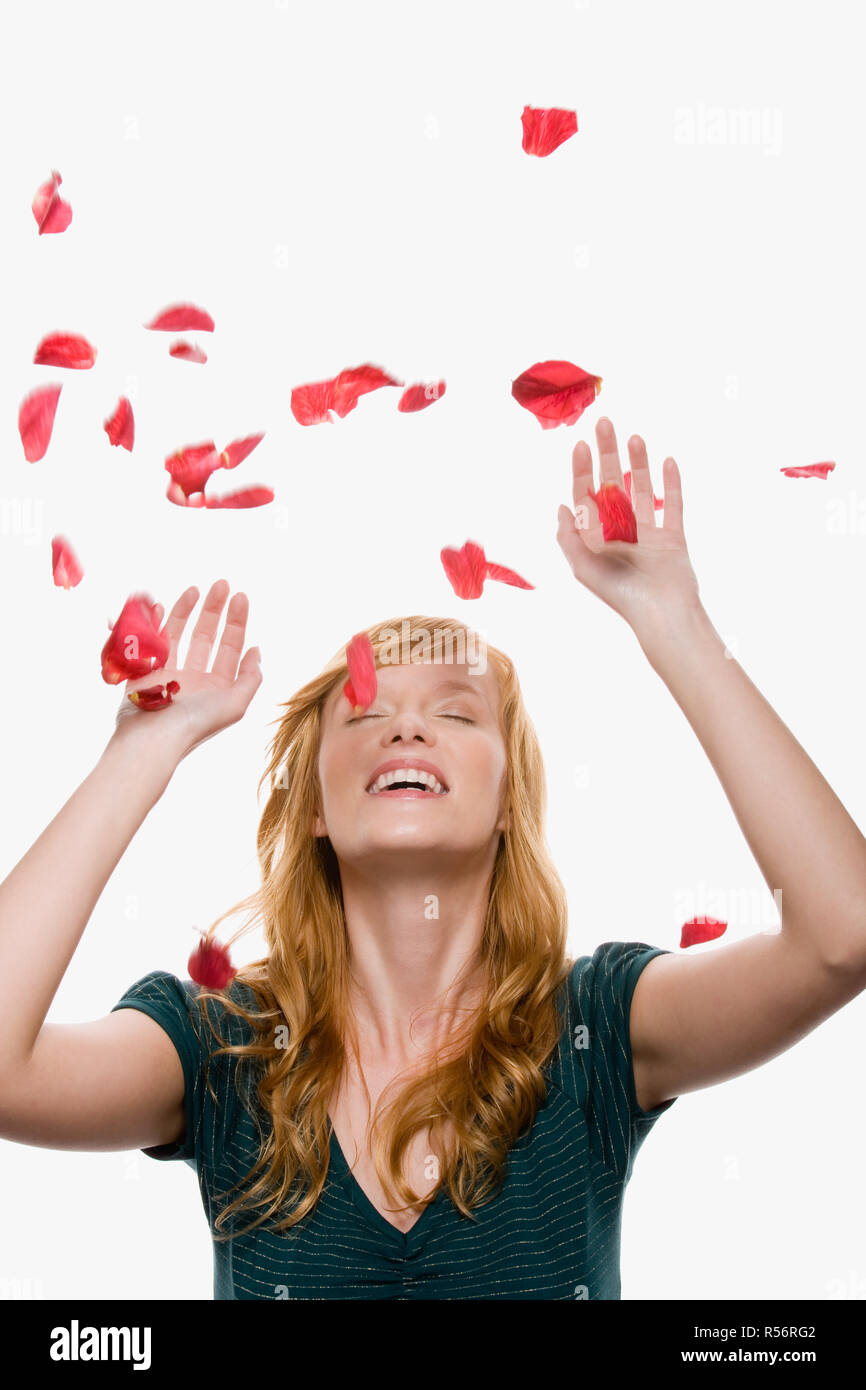 Petals falling on a woman Stock Photo - Alamy