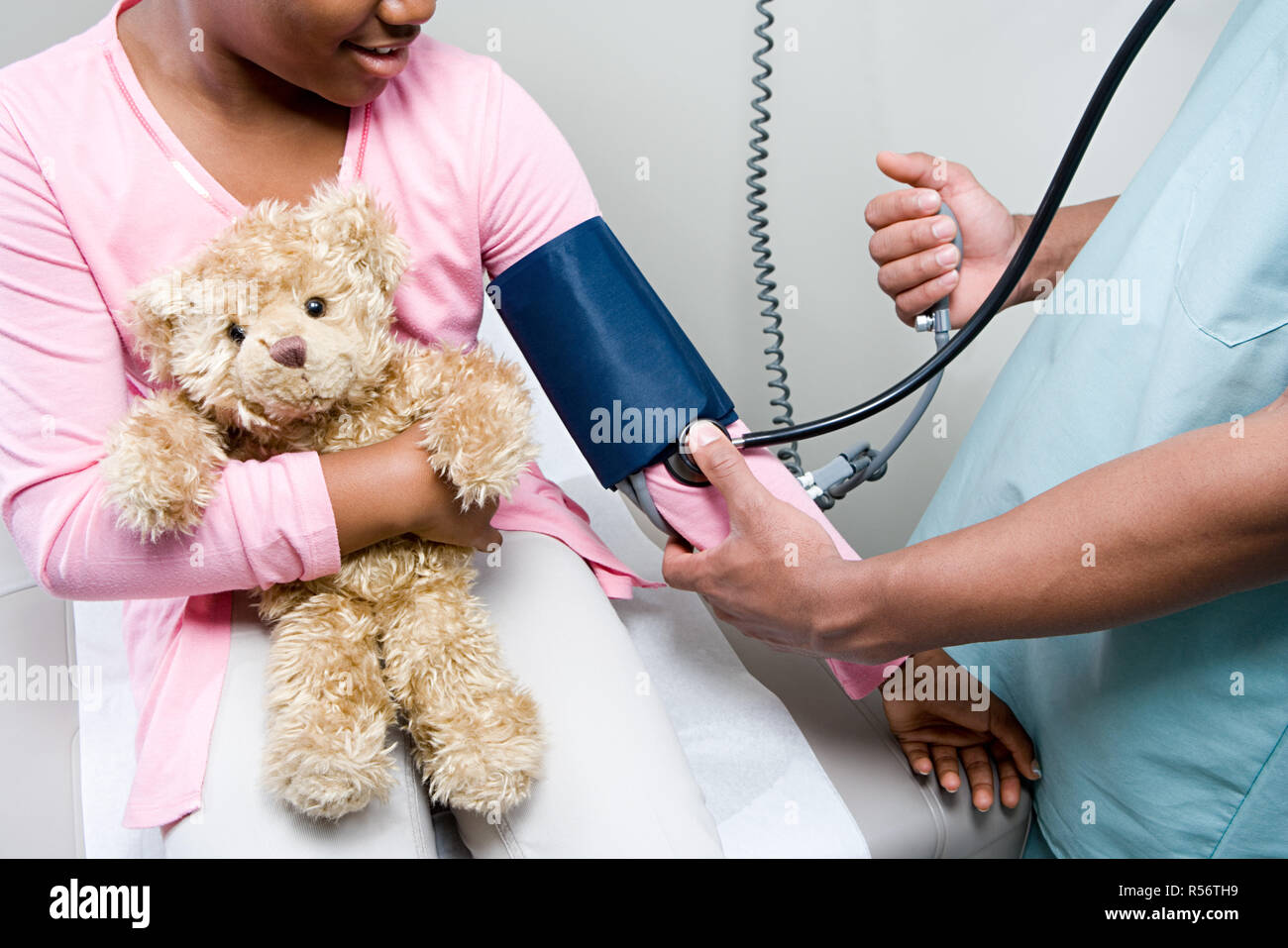 Doctor checking girl Stock Photo - Alamy Doctor checking girl Stock Photo - Alamy