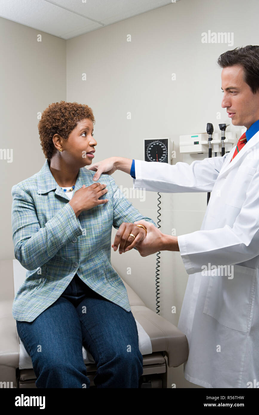 Doctor examining woman Stock Photo - Alamy