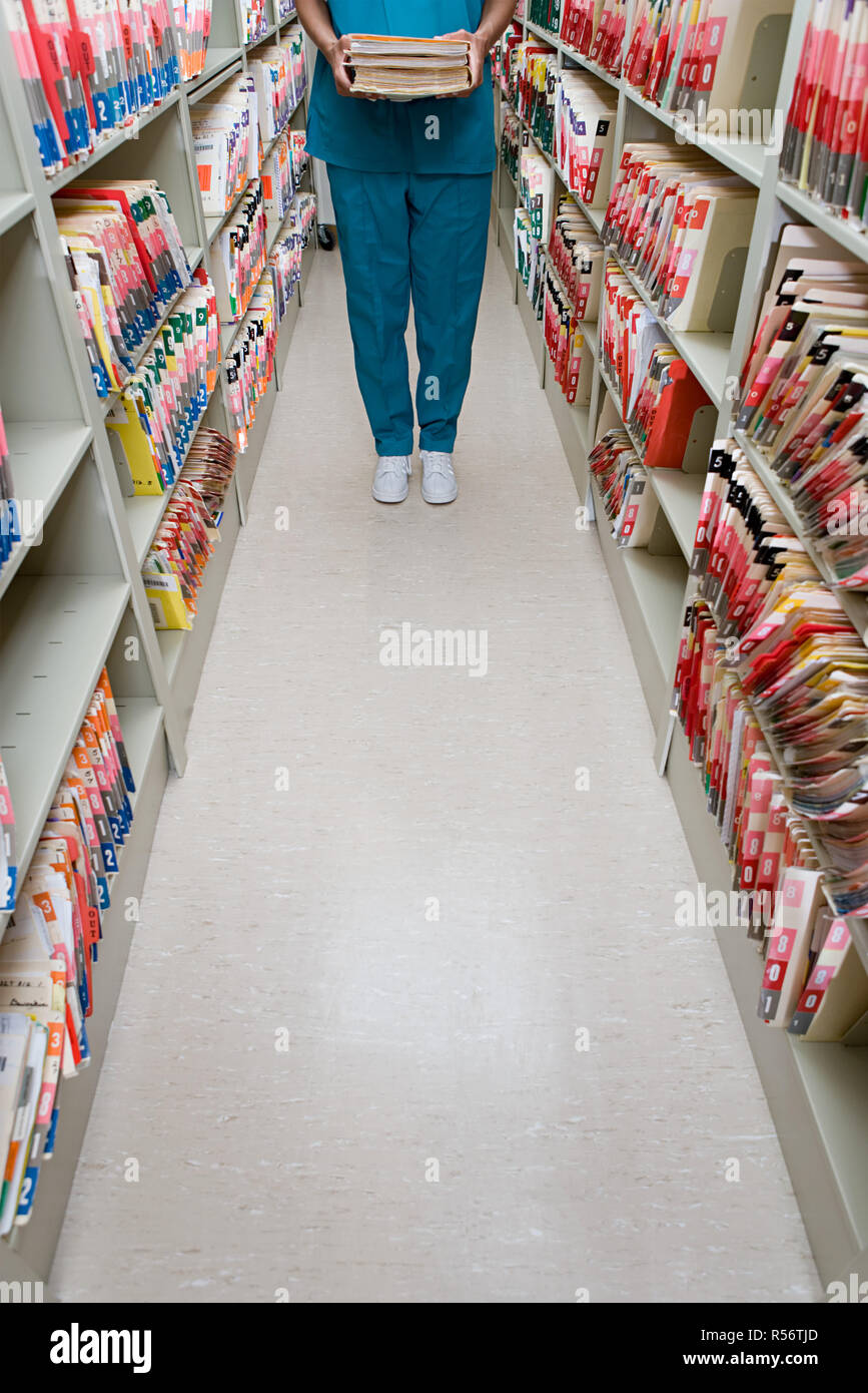 Hospital orderly in archives Stock Photo - Alamy