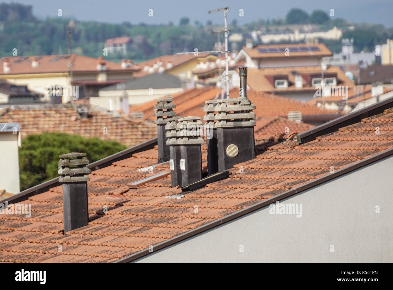 Old clay chimney pots and brick chimney stacks on old tiled roof ...