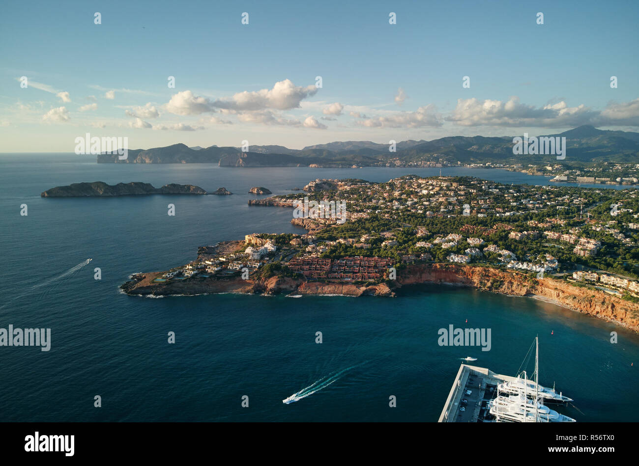 Aerial view Port Adriano, located just below the cliffs of the small ...