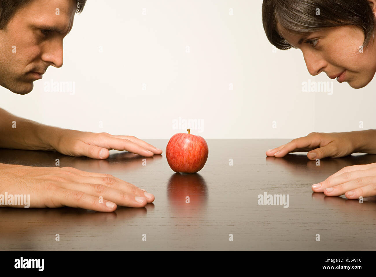 Couple staring at apple Stock Photo - Alamy