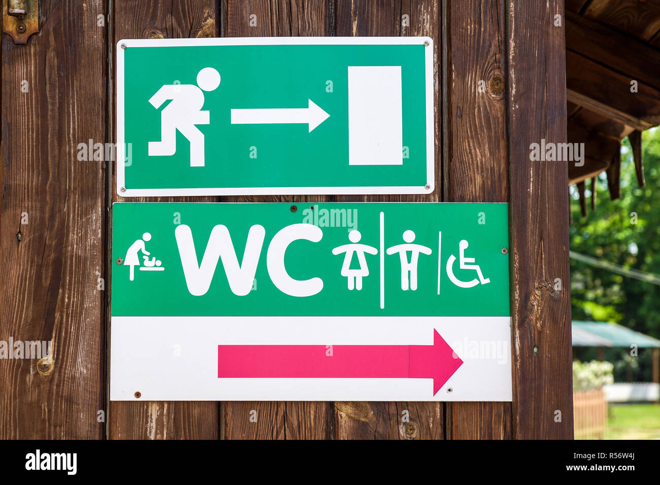 woman man disabled toilet sign and emergency exit sign Stock Photo - Alamy