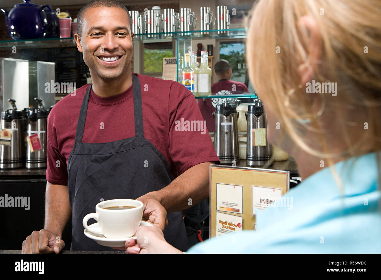 Waiter serving customer Stock Photo - Alamy