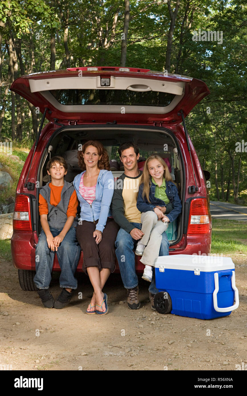 Family sitting in back of car Stock Photo - Alamy