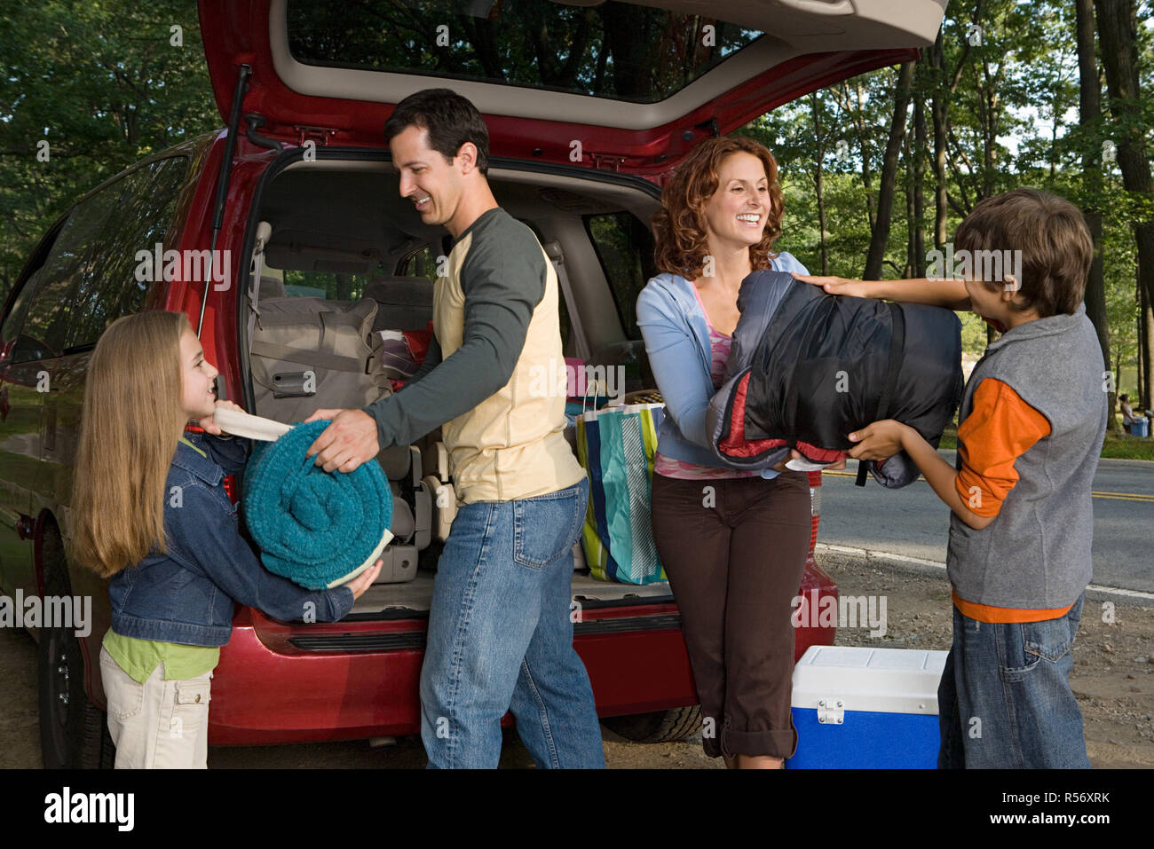 Family unpacking car Stock Photo - Alamy