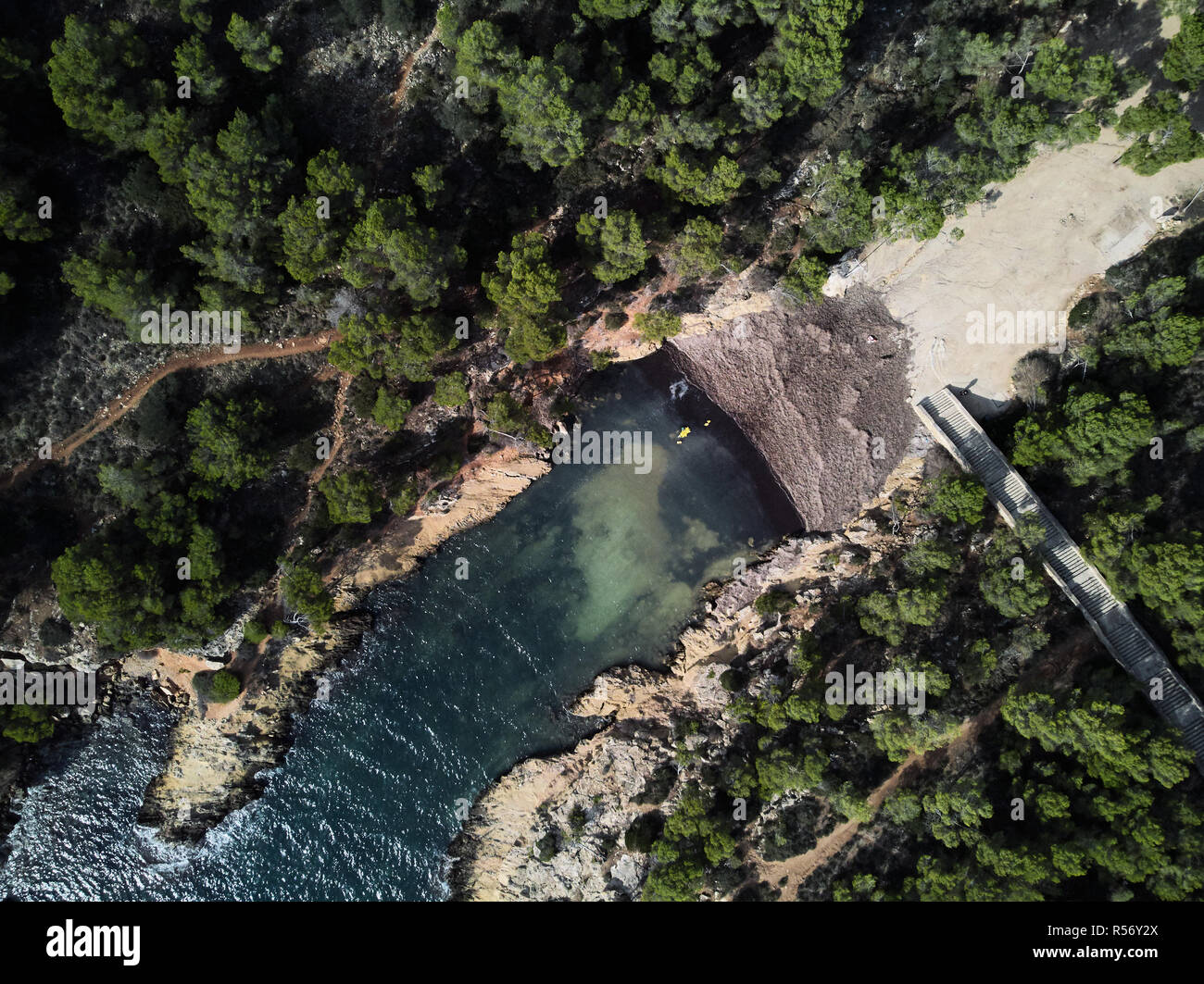 Cap falco beach with turquoise green transparent water and rocky coast ...