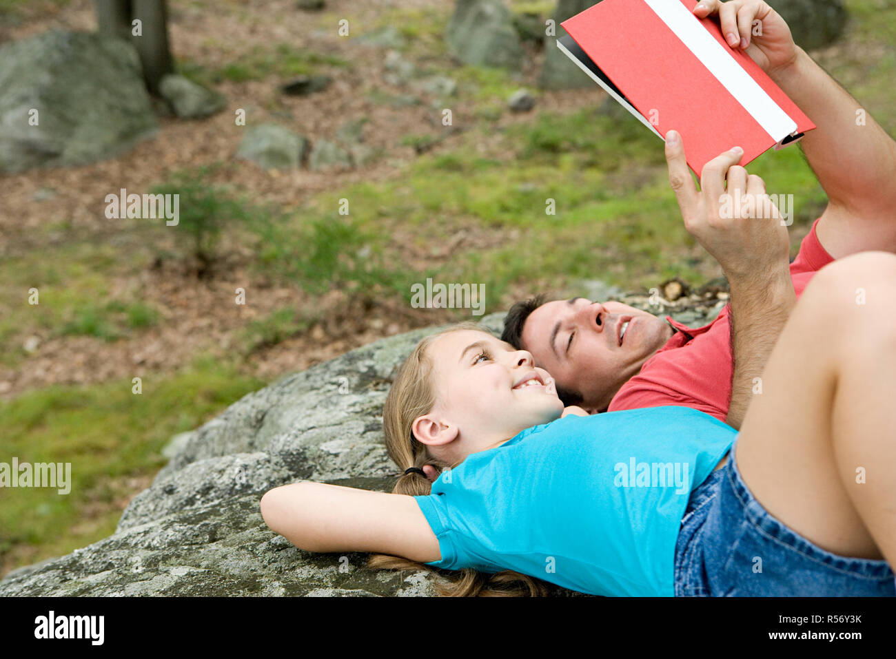 Girl lying on rocks hi-res stock photography and images - Alamy