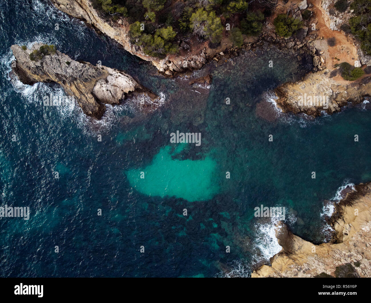 Cap falco beach with turquoise green transparent water and rocky coast ...
