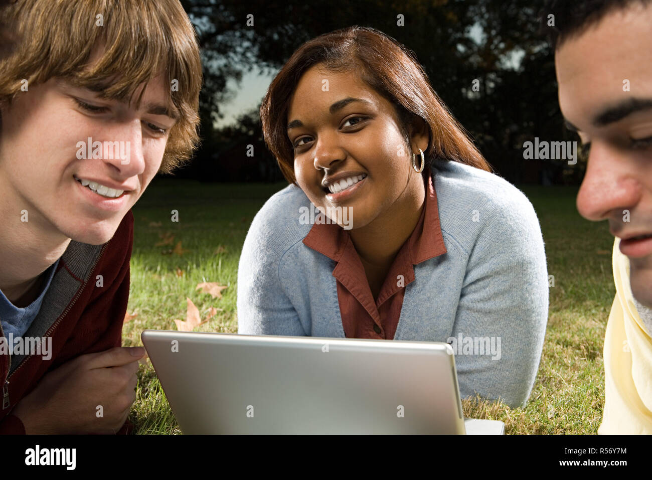 Three students studying outdoors Stock Photo - Alamy
