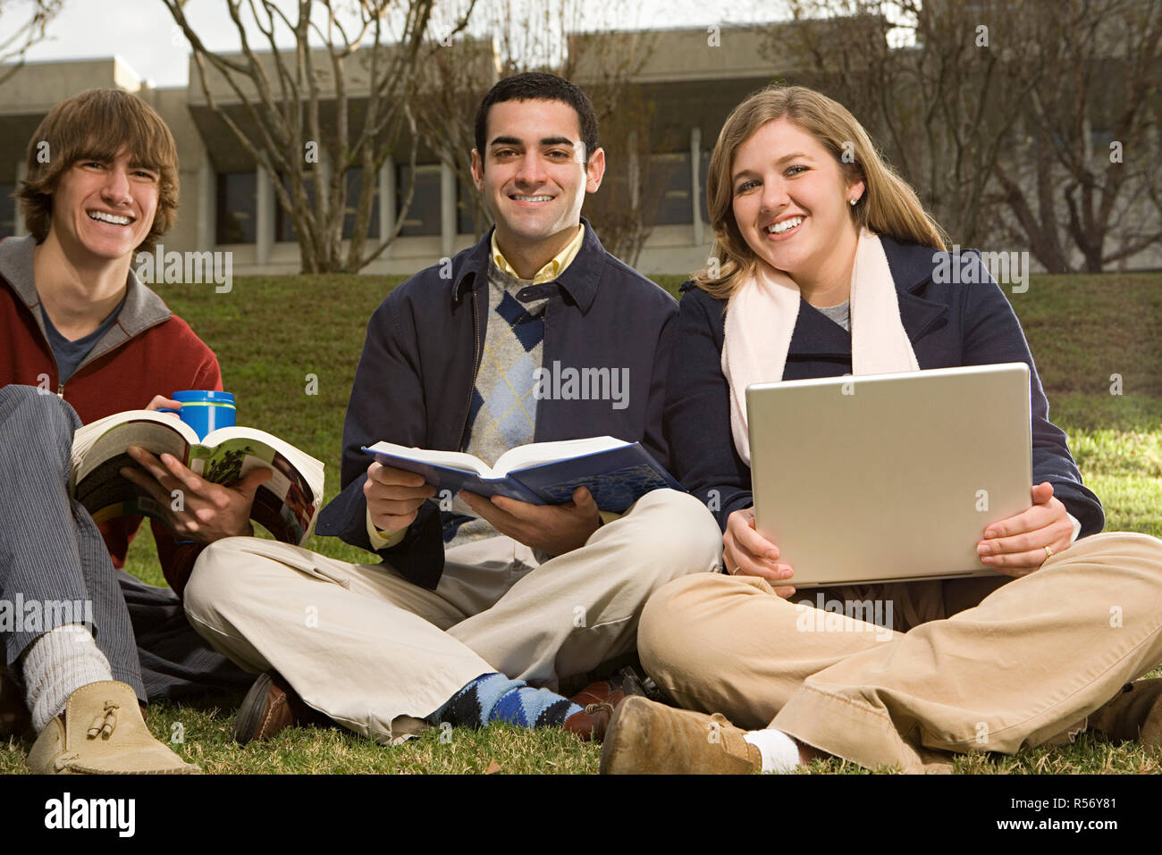 Three students sat outdoors Stock Photo - Alamy