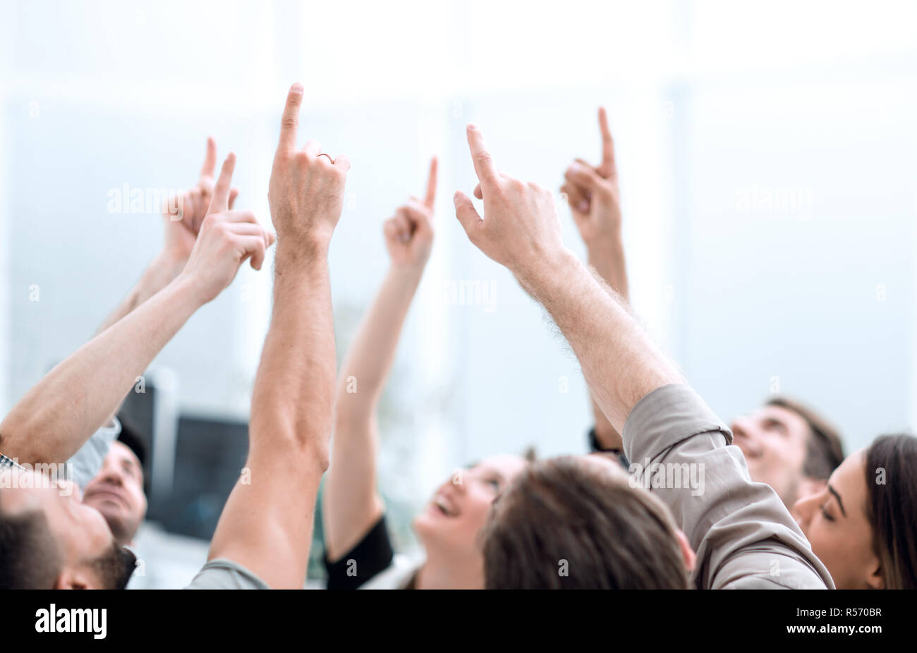 business team pointing fingers up Stock Photo - Alamy