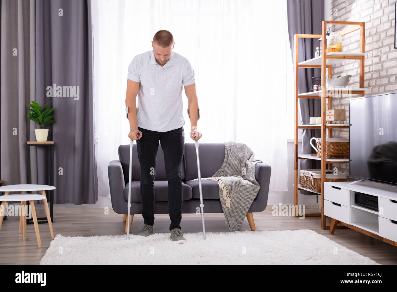 Person on crutches hi-res stock photography and images - Alamy