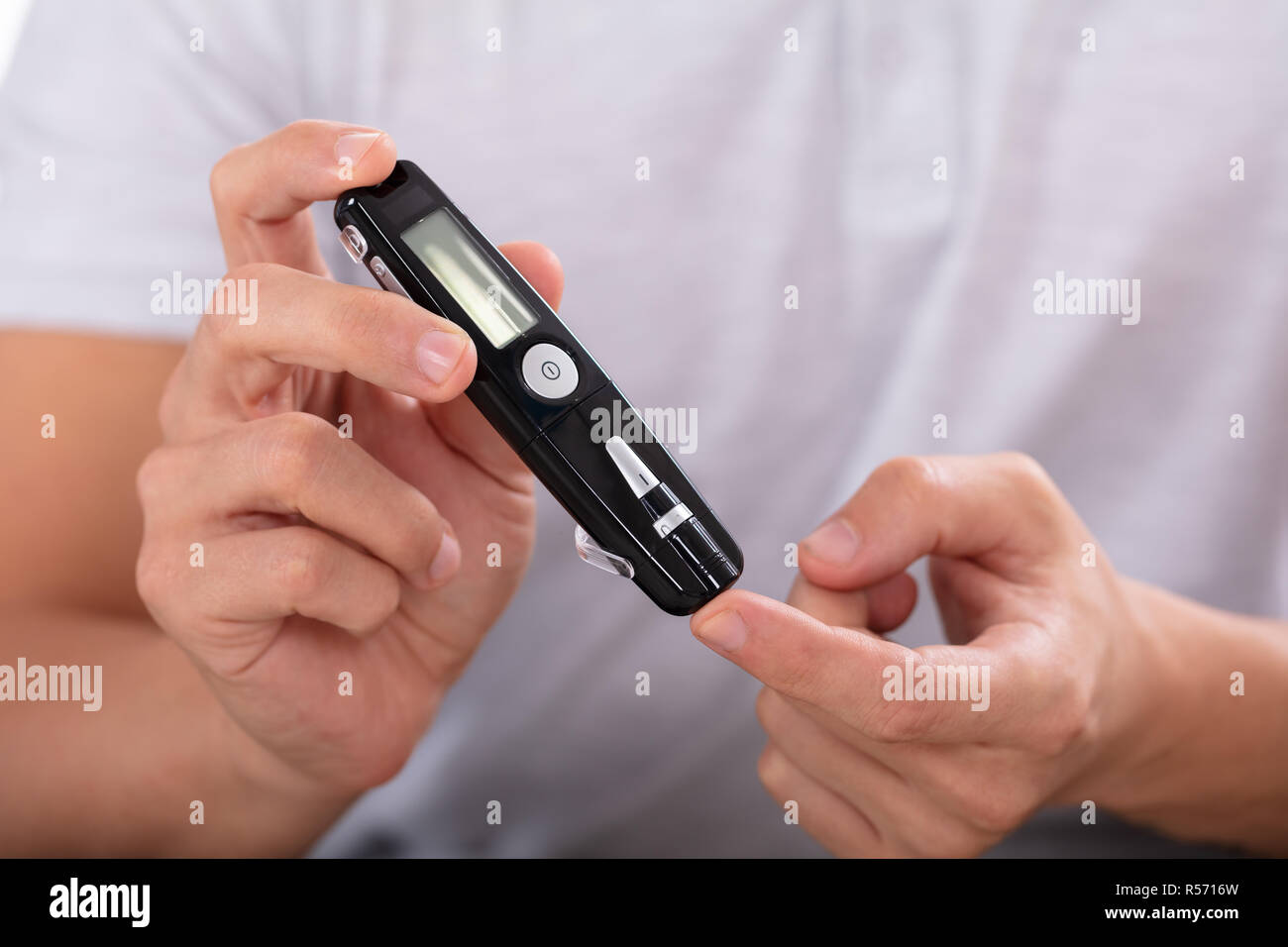 Close-up Of A Man's Hand Checking Blood Sugar Level With Glucometer ...