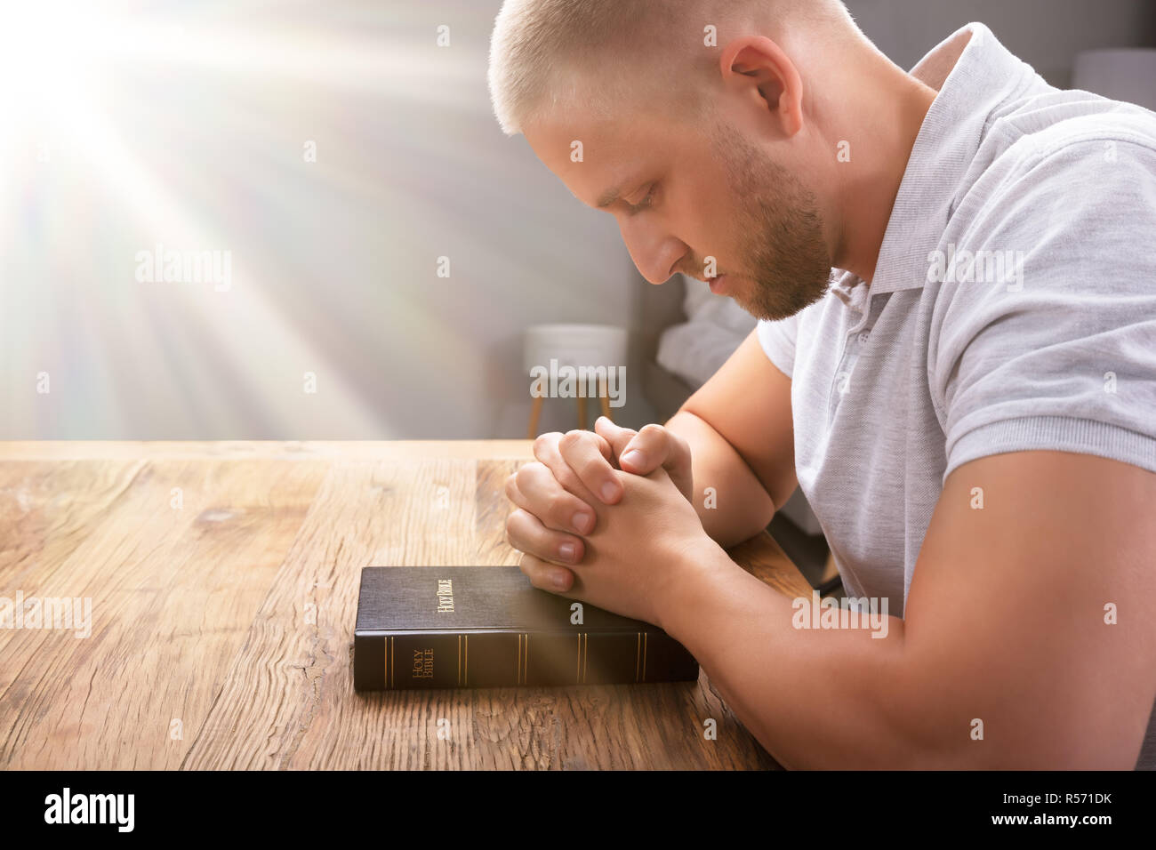 Praying hand with bible hi-res stock photography and images - Alamy
