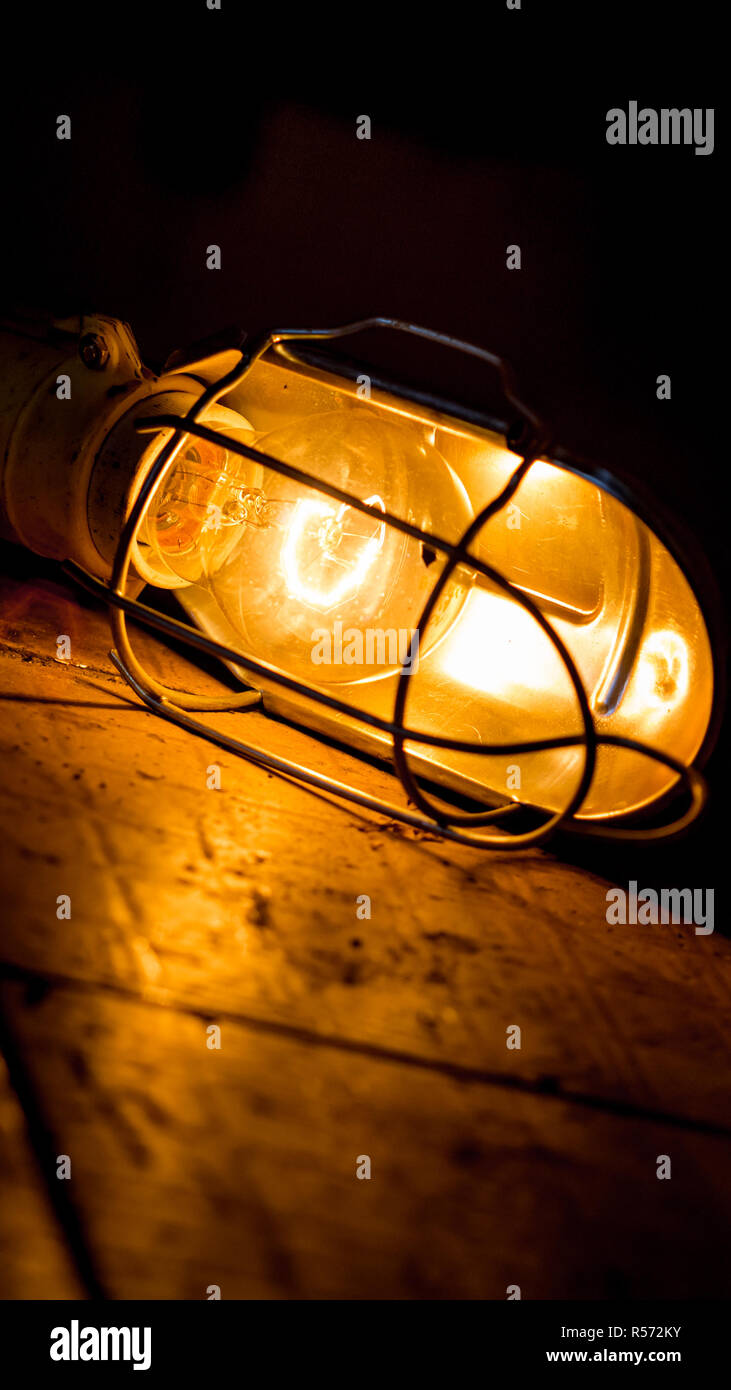 Light bulb in metal case on tiles in car mechanic workshop Stock Photo ...