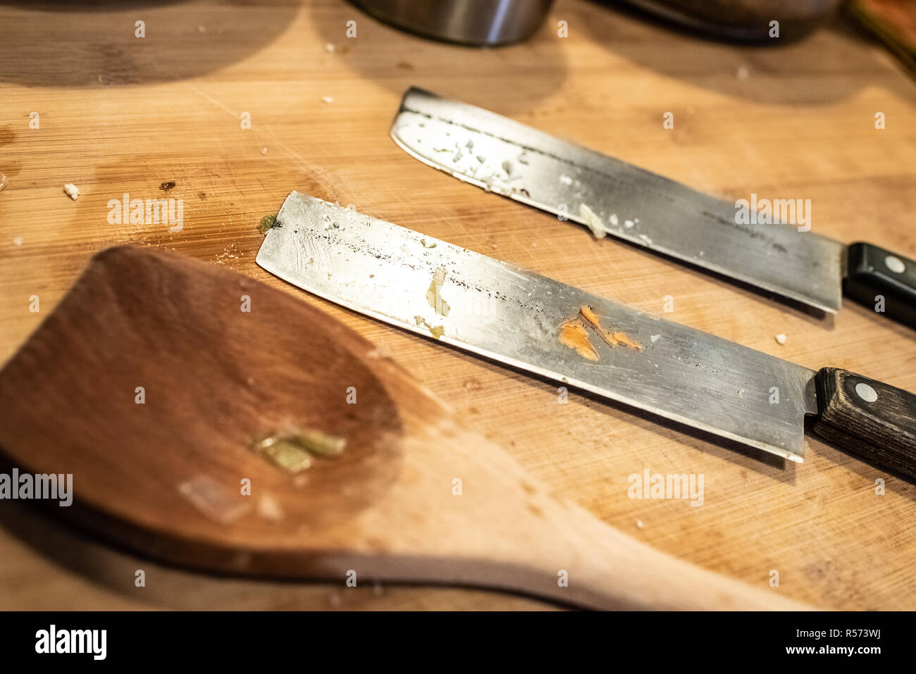 Steel kitchen knives and wooden spoon Stock Photo - Alamy