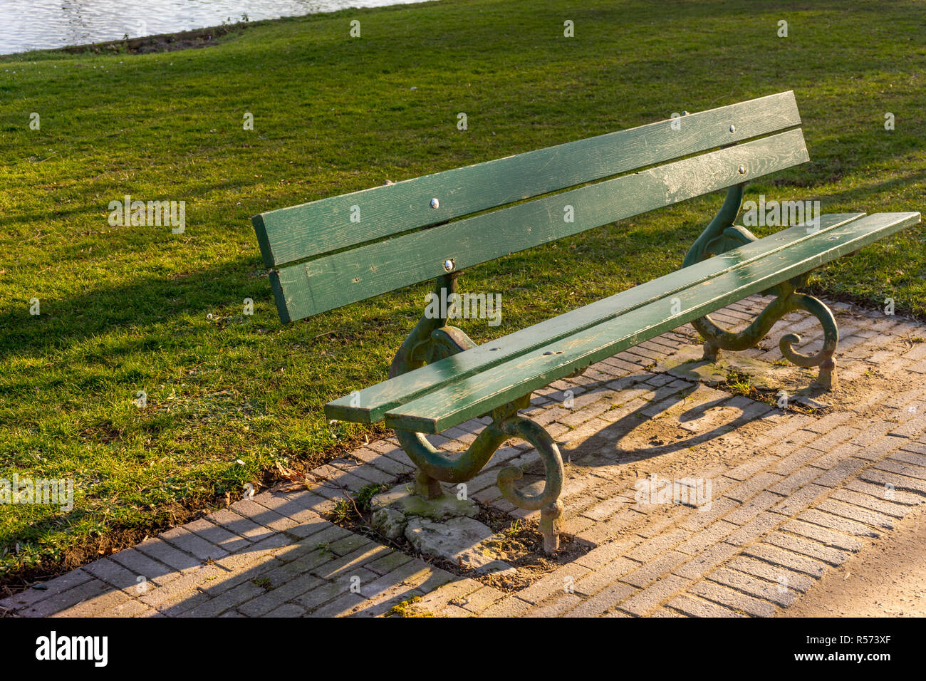 Europe, Belgium, Bruges, an empty park bench sitting in the grass Stock ...