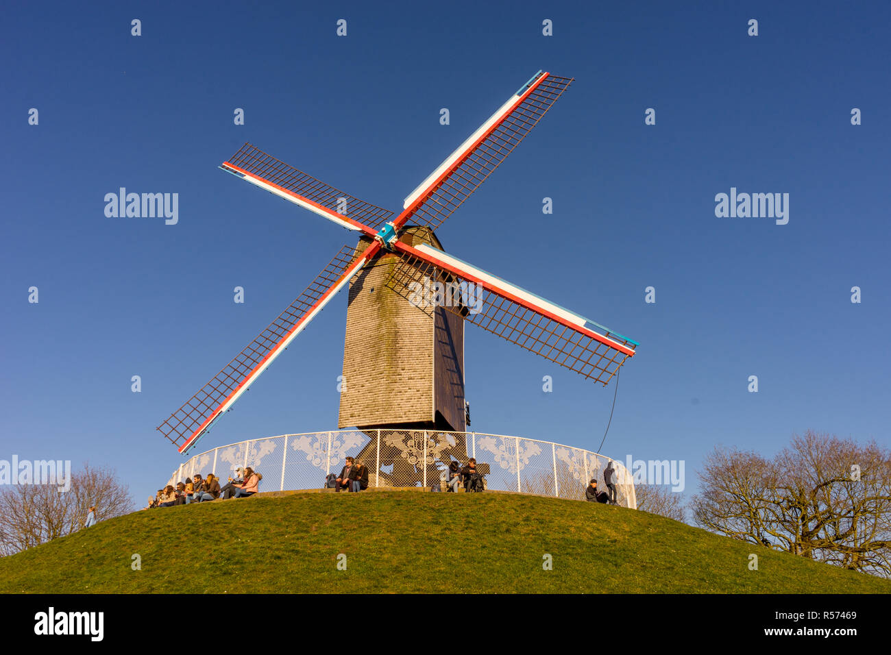 Europe, Belgium, Bruges, a windmill on top of a grass covered field ...
